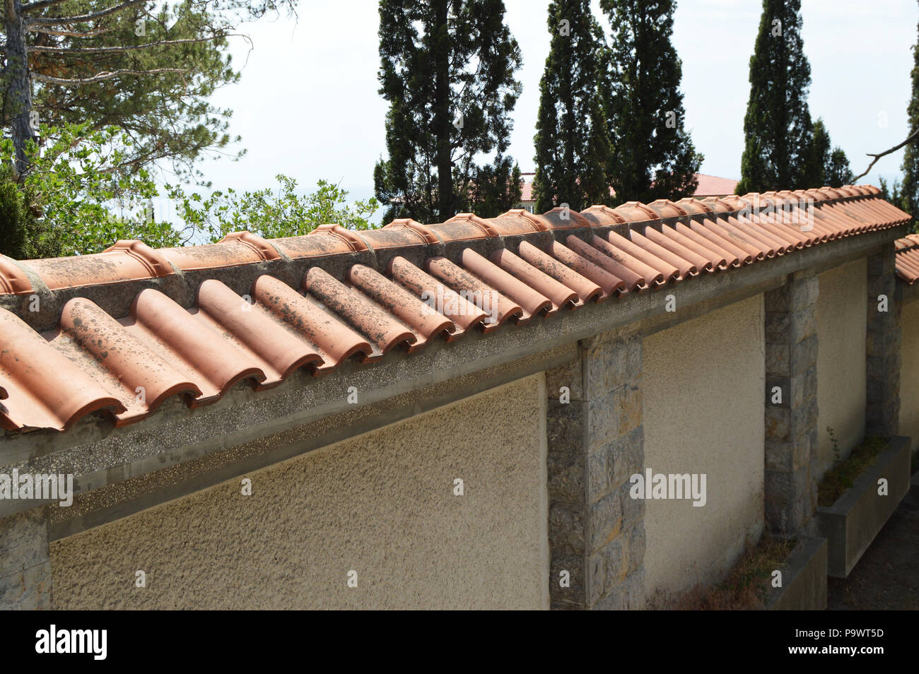 Modern stone fence with roof for private property protection and ...