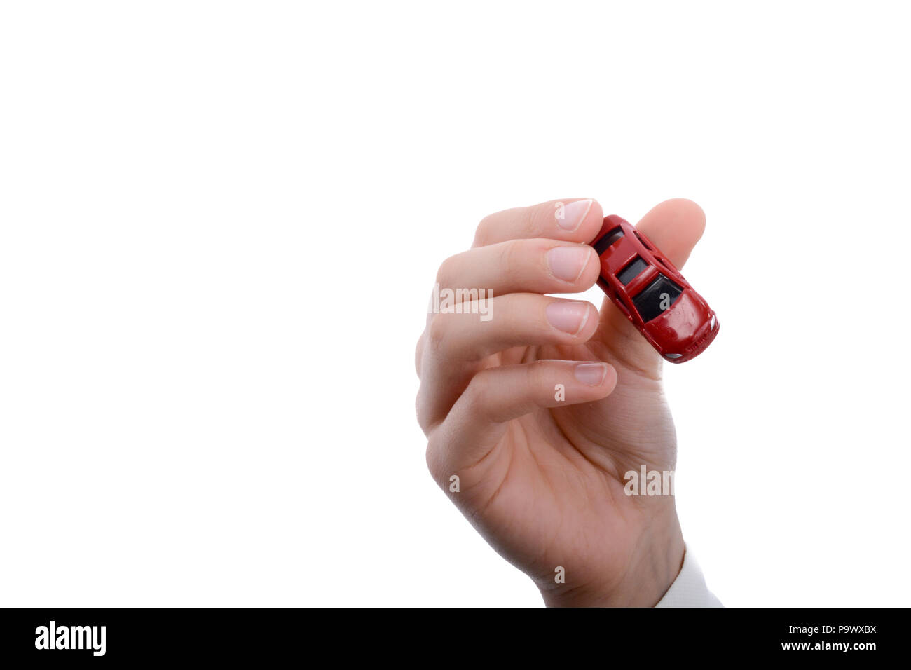 Child's hand holding a red car on a white background Stock Photo - Alamy