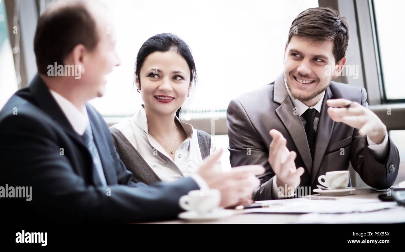 Portrait of smart business partners communicating in meeting Stock ...