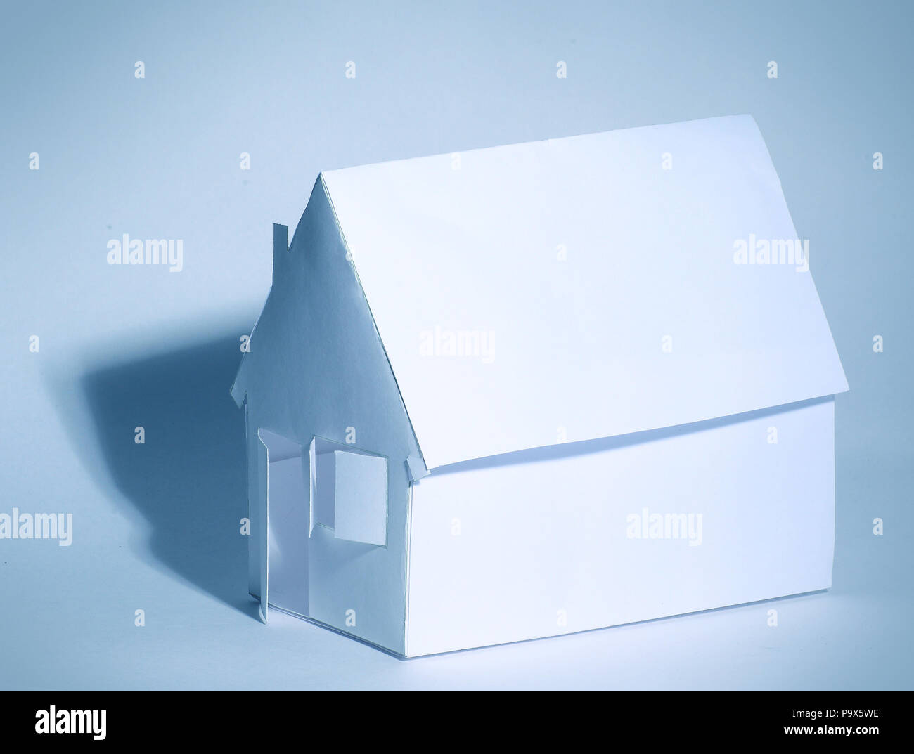 Paper house on a white background in cool colors Stock Photo - Alamy