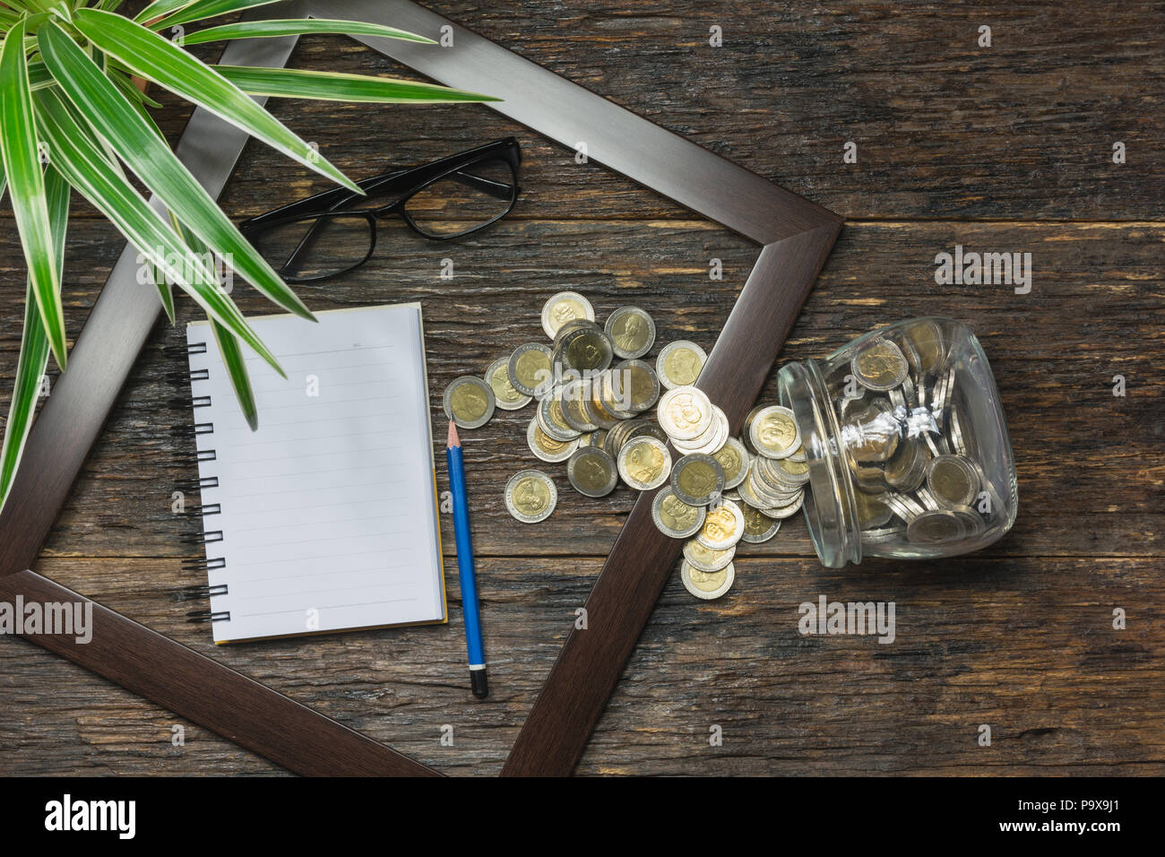 Top view of stack of coin in the frame accounting concept on wooden ...