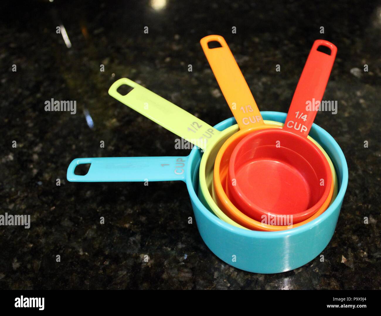 Colorful Measuring Cups on Counter Stock Photo - Alamy