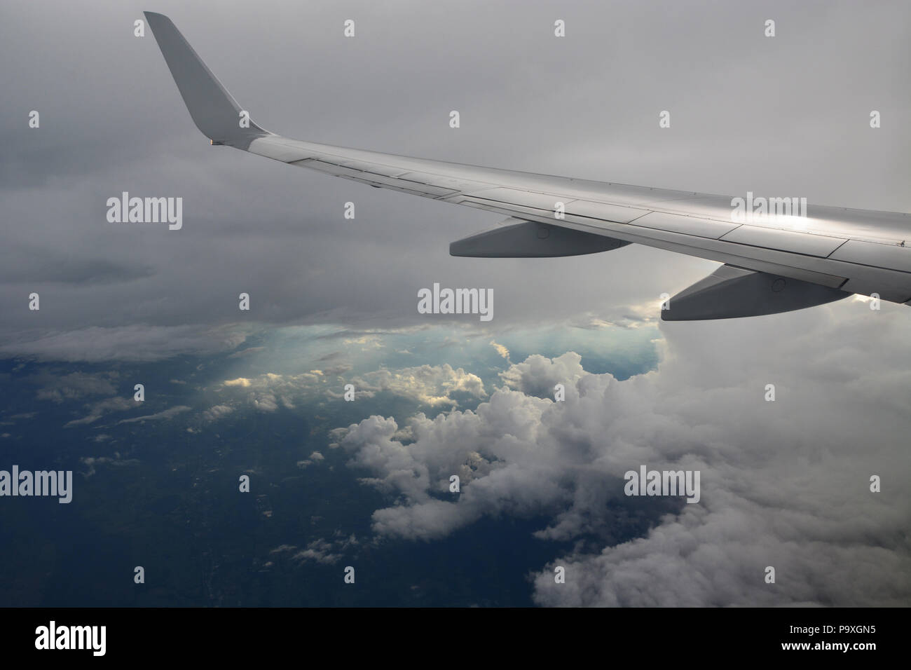 The view from a passenger jet flying high over storm clouds in the ...