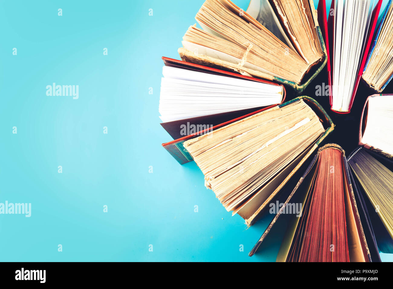 Pile of old books close up on blue background with copy space, retro toned Stock Photo - Alamy