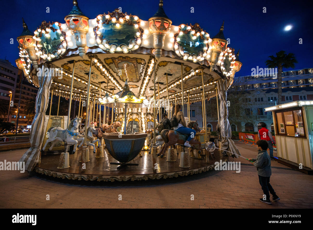 Children's vintage Carousel at an amusement park in the evening and ...