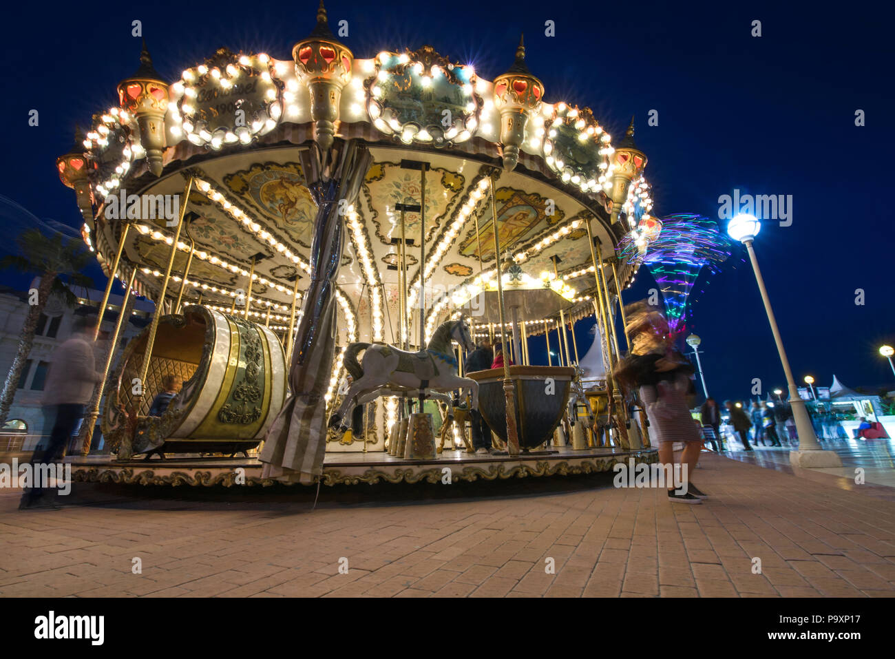 Children's vintage Carousel at an amusement park in the evening and ...