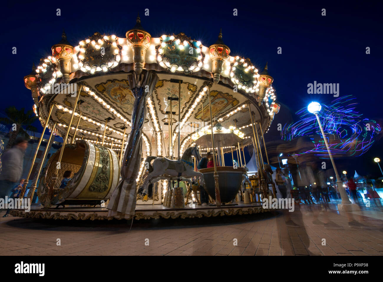 Children's vintage Carousel at an amusement park in the evening and ...