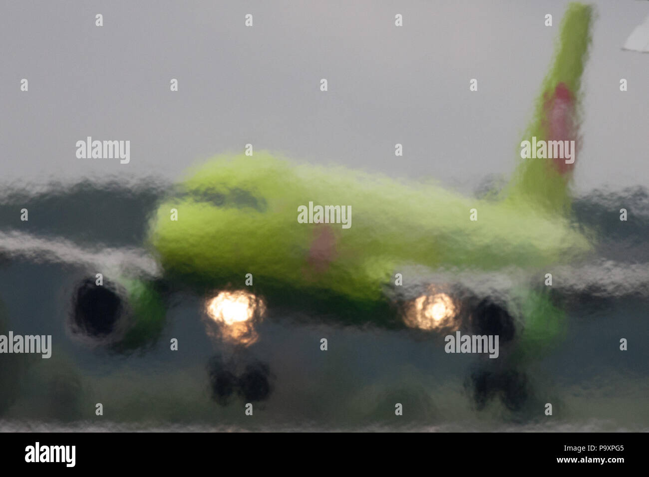 The Airbus A320 of S7 Airlines blurred by the jet exhaust of another ...