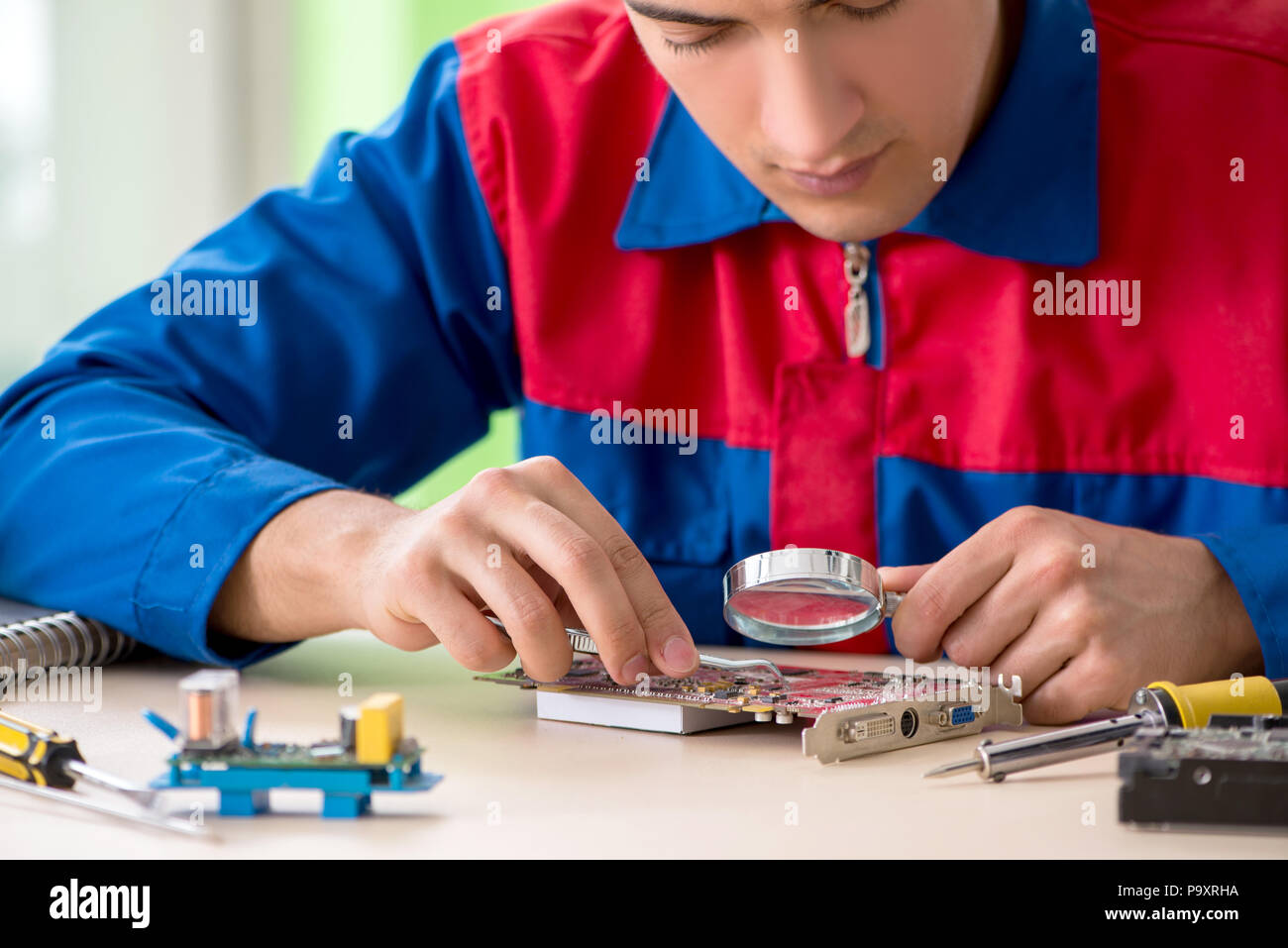 Computer engineer repairing broken desktop Stock Photo - Alamy