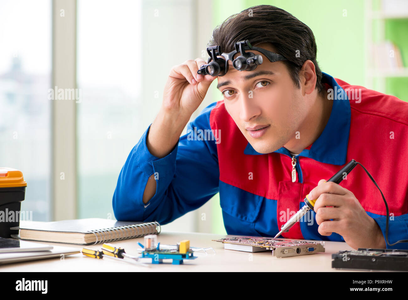 Computer engineer repairing broken desktop Stock Photo - Alamy