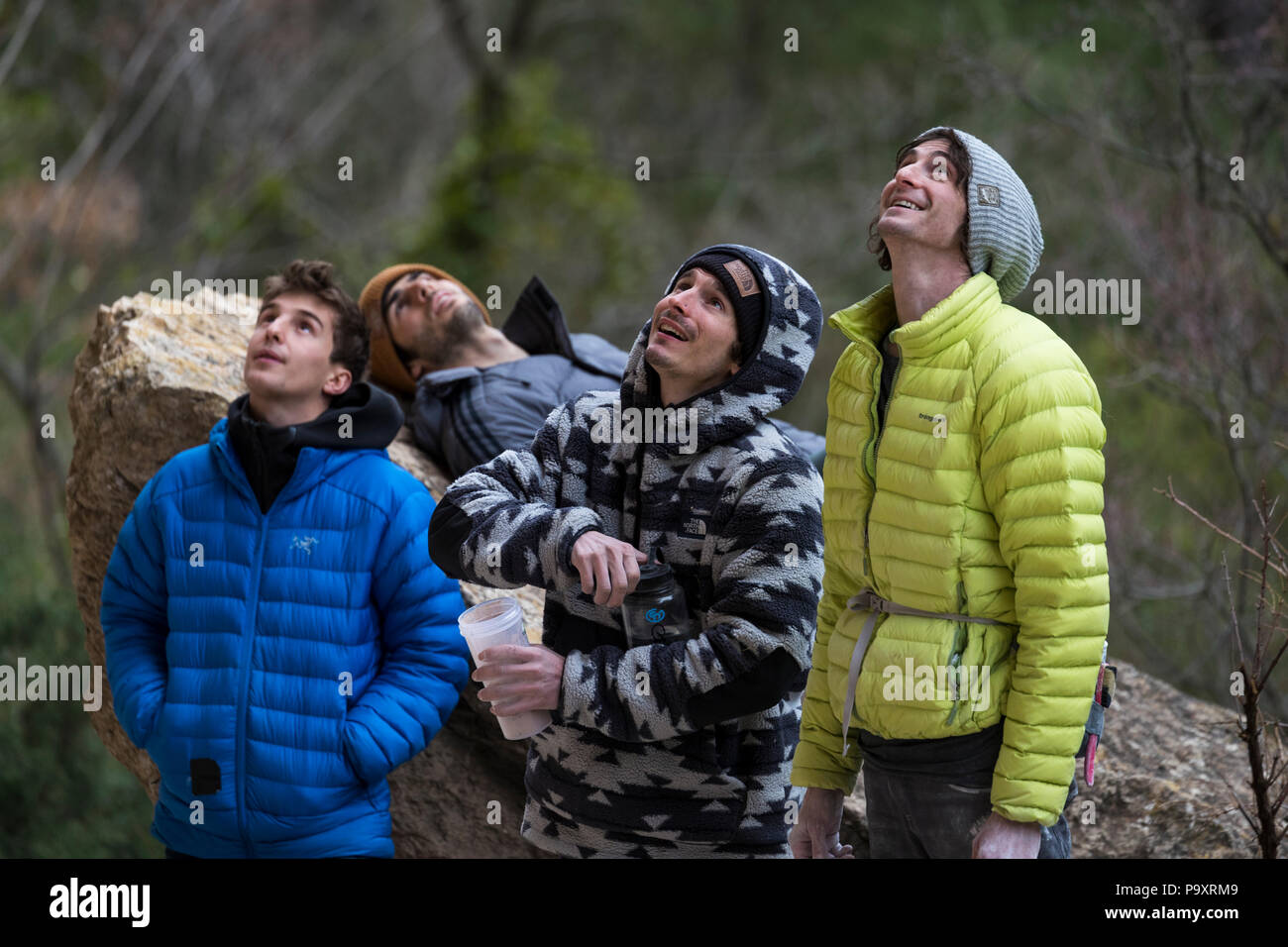 Four men watching rock climbers hi-res stock photography and images - Alamy