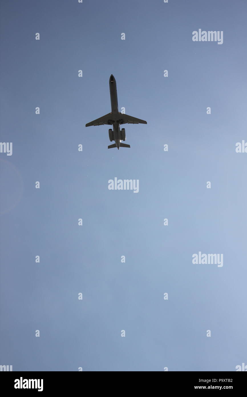 Jet plane flying overhead and landing at O'Hare Airport CTA Blue train ...