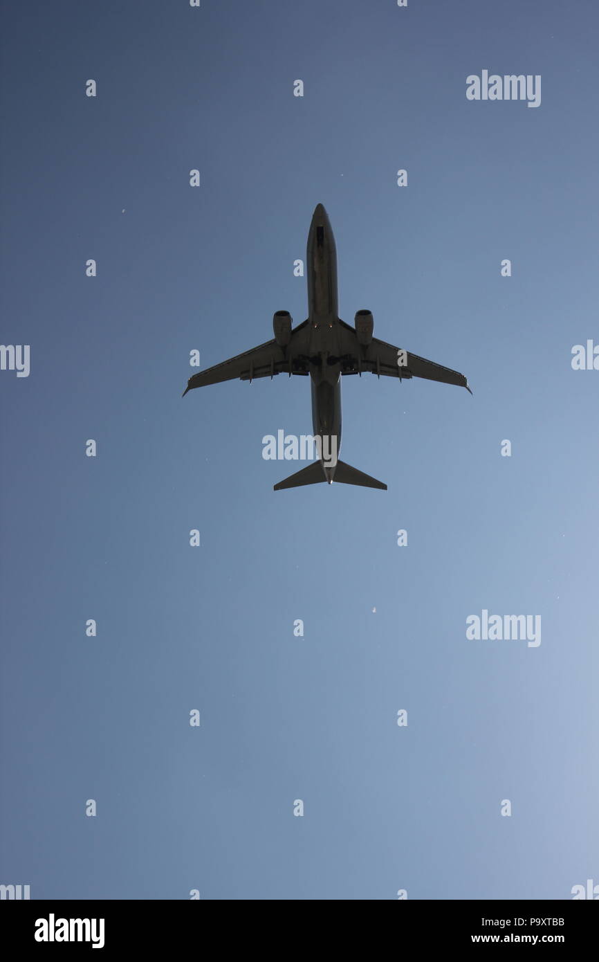 Jet plane flying overhead and landing at O'Hare Airport CTA Blue train ...