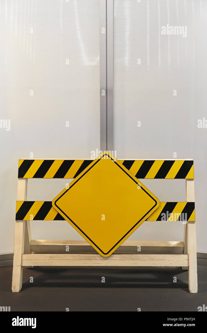 Blank yellow sign at construction barrier Stock Photo - Alamy