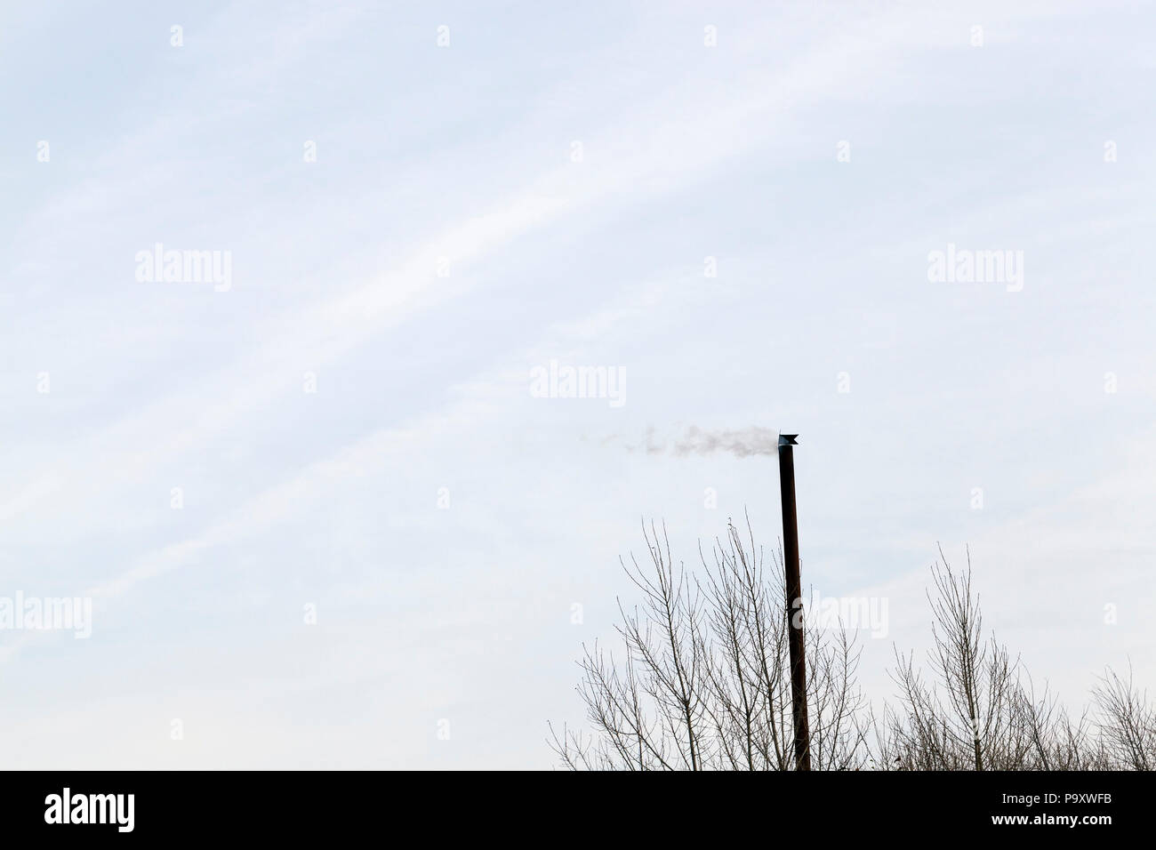 a thin pipe from the boiler-house from which smoke is during the ...