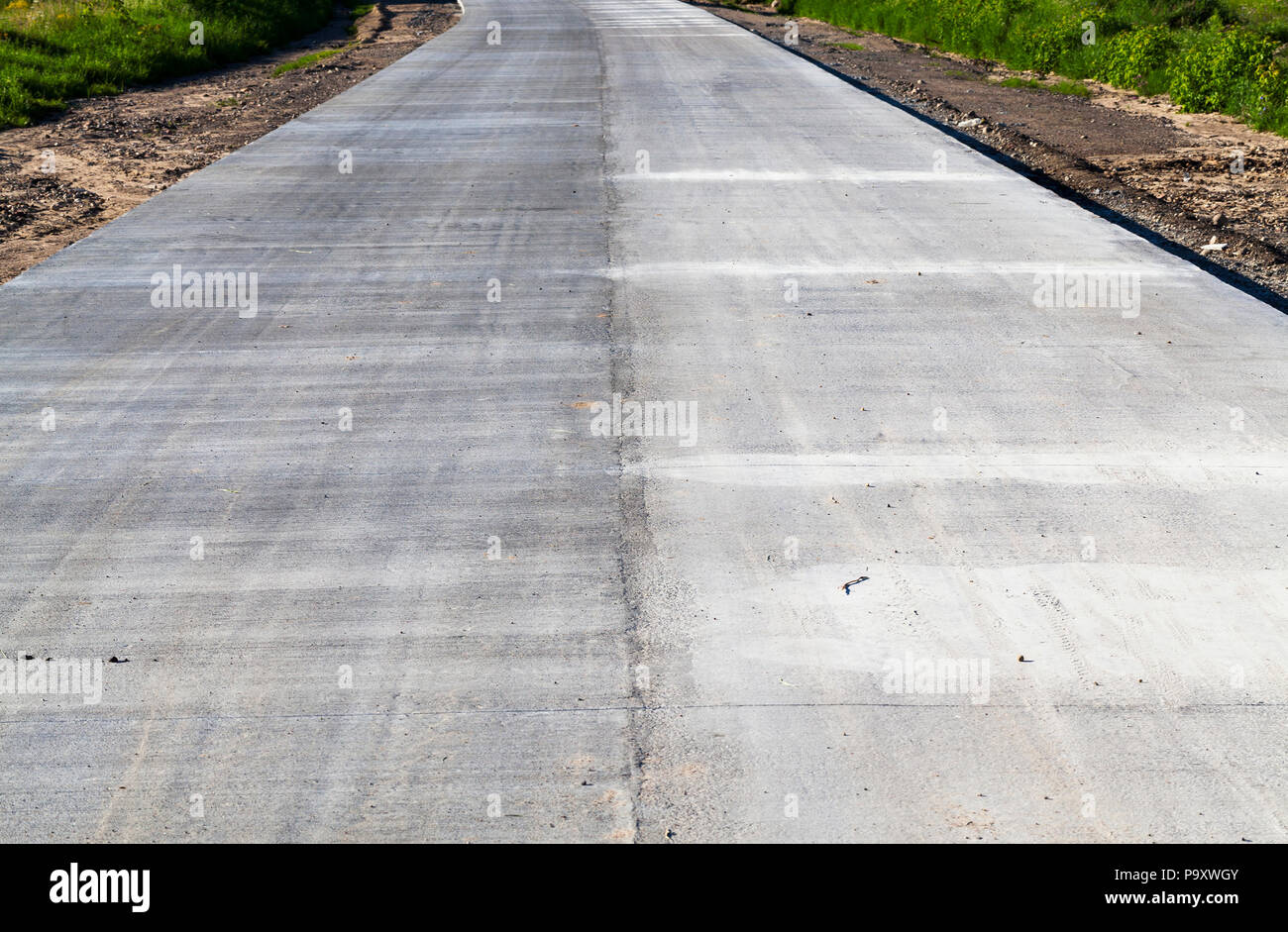 construction of a new road from concrete by technology, photo closeup ...