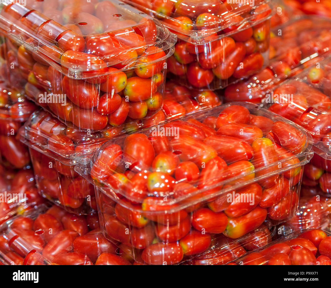 Cherry Tomatoes in see-through plastic containers on display in grocery. Isolated. Stock Image ...