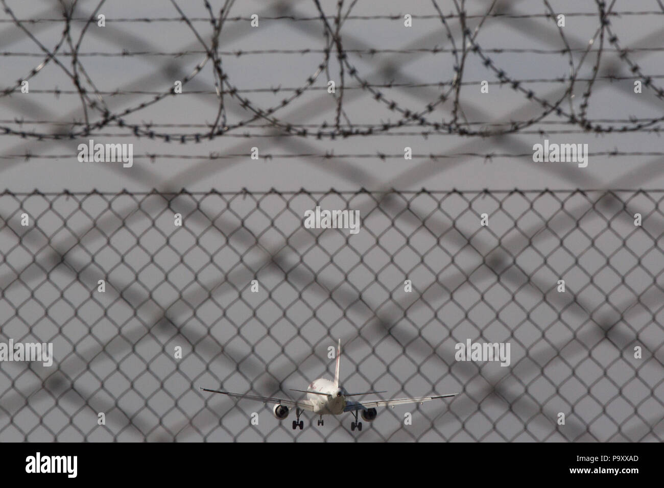 The Airbus A320 seen through the wired fence as it approaches Milan ...