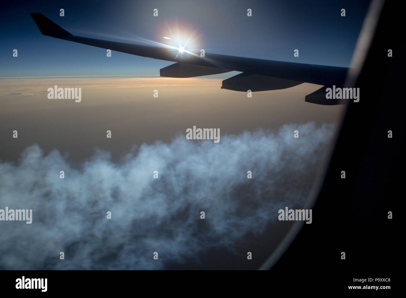 The sunrise window view from the Airbus A330 producing contrail over ...
