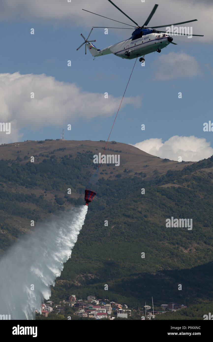 The Mil Mi-26T heavy helicopter equipped with a firefighter device ...