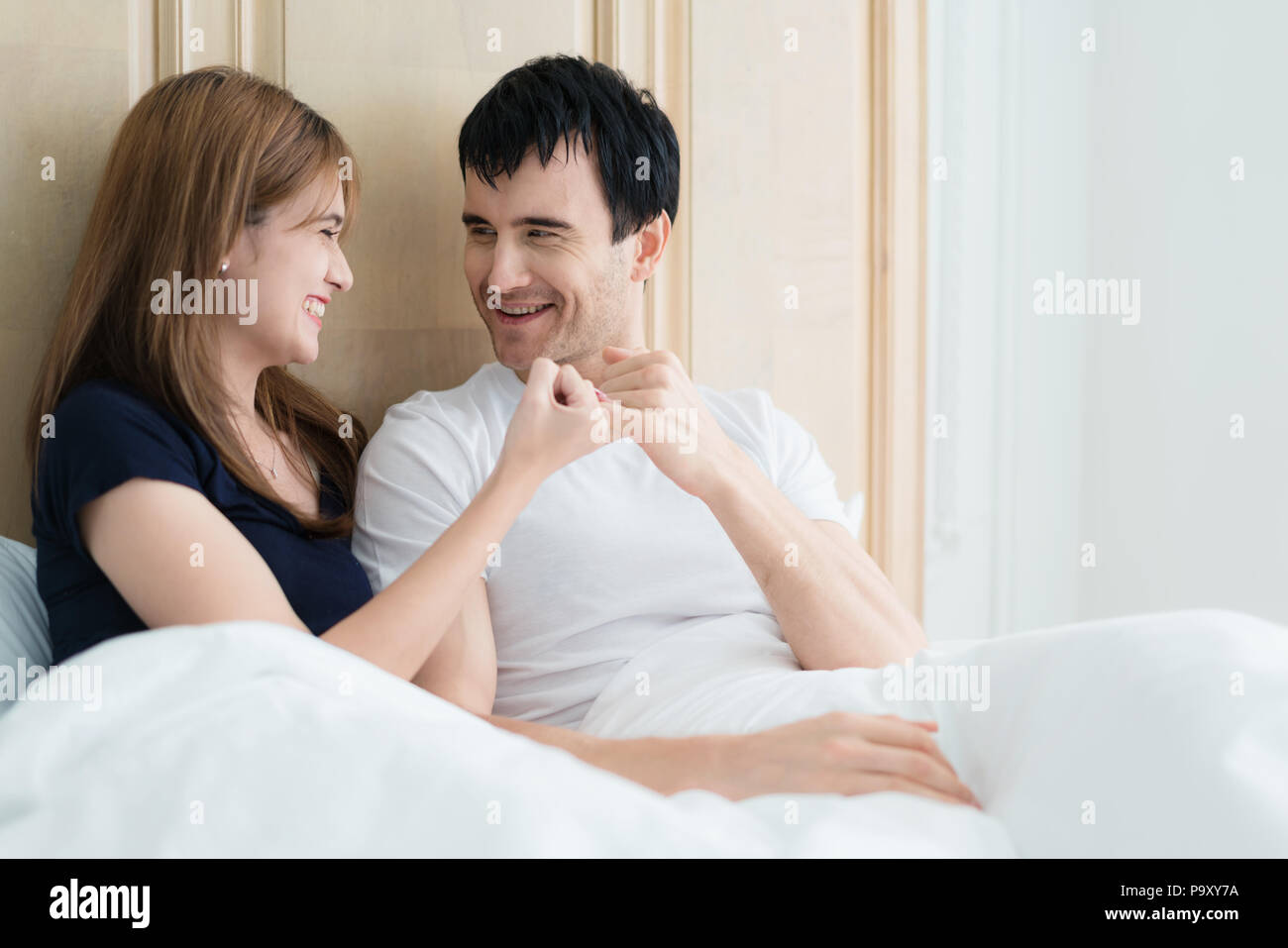 Couple hands show little finger on sofa in house. Romantic love concept ...