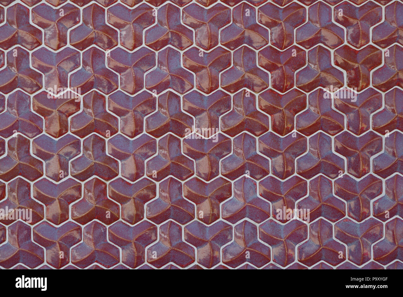Convex burgundy tiles of regular geometric shape with curved facets as ...