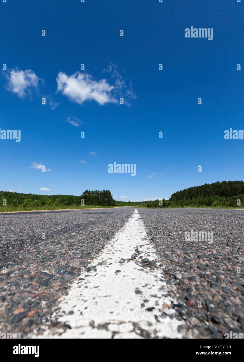 empty asphalt road with a white strip of road markings, a photo in the ...