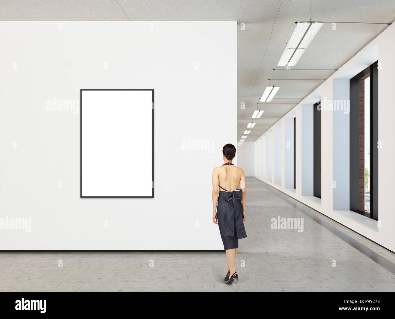 Woman looking at blank vertical poster in modern gallery. Poster ...