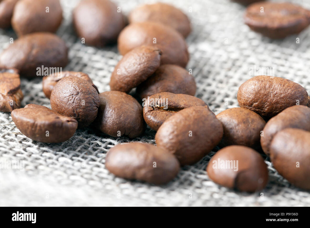roasted coffee beans on coarse linen material during sale in the store ...