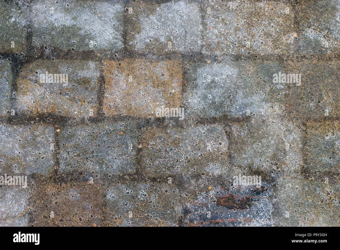 Cobbles on the street under a thin layer of ice with sand Stock Photo ...