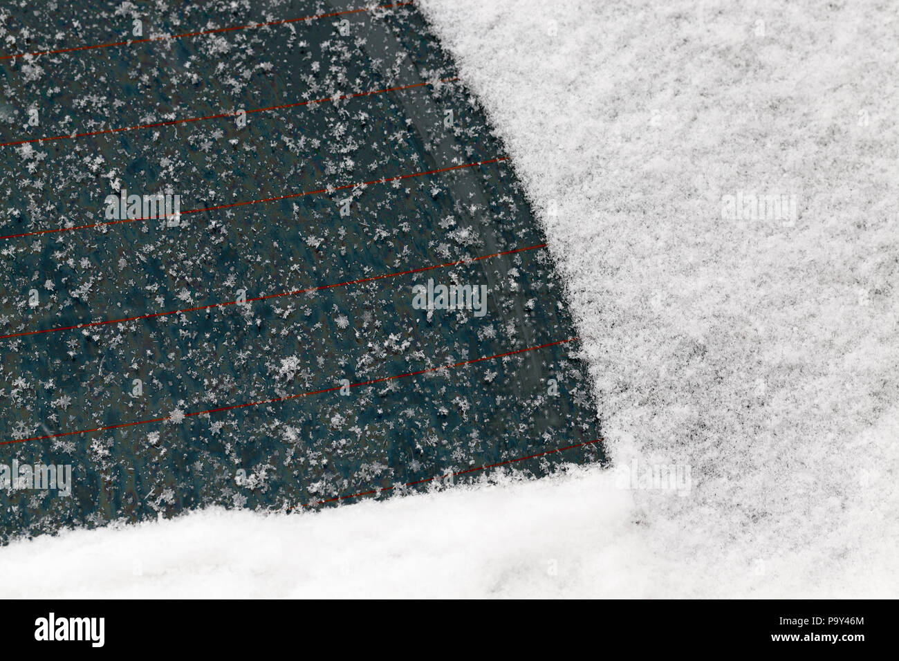 melting snow on the rear window of the car. Small depth of field. Photo ...