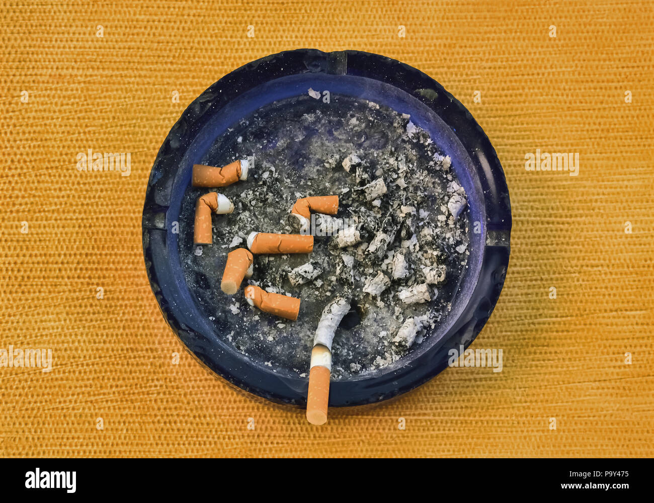Closeup of an ashtray full of cigarettes viewed from above Stock Photo ...