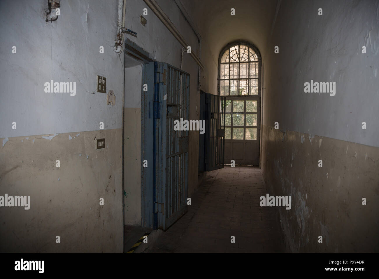 Long Corridor and White and Worn Walls of a Prison Stock Photo - Alamy