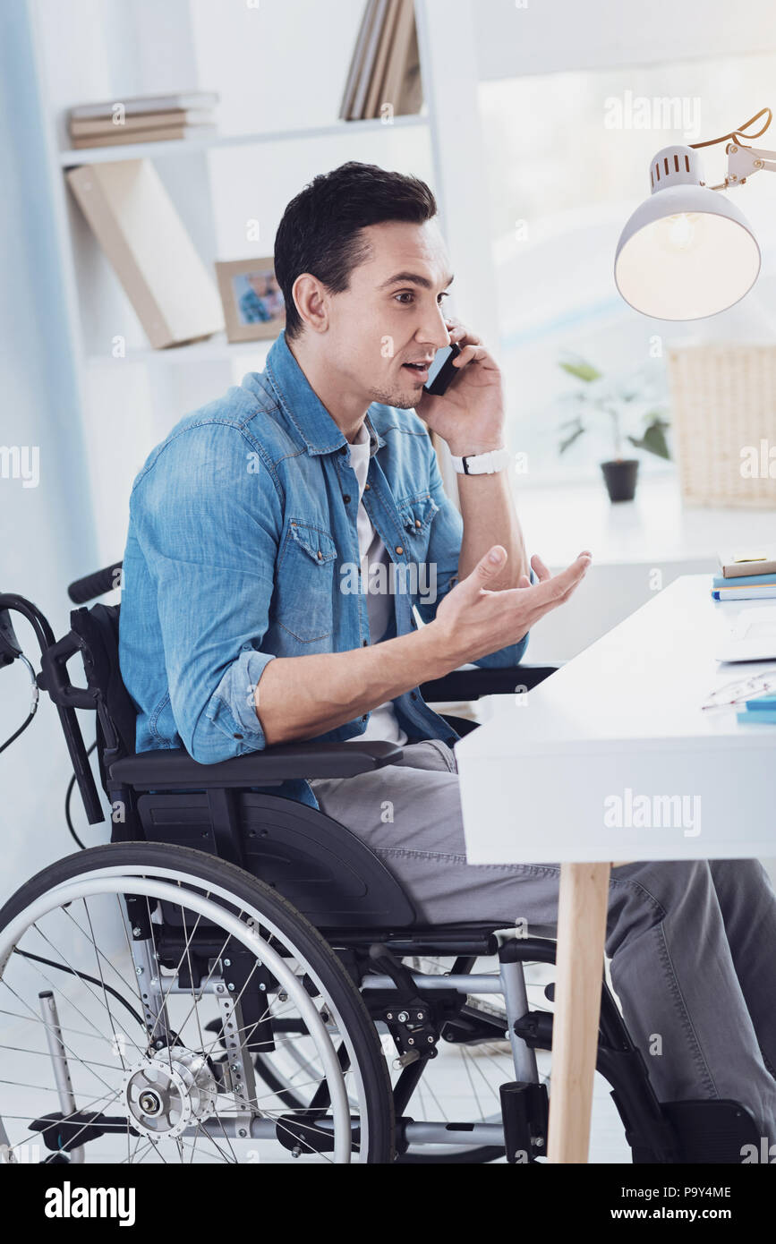 Busy brunette gesticulating while talking per telephone Stock Photo - Alamy