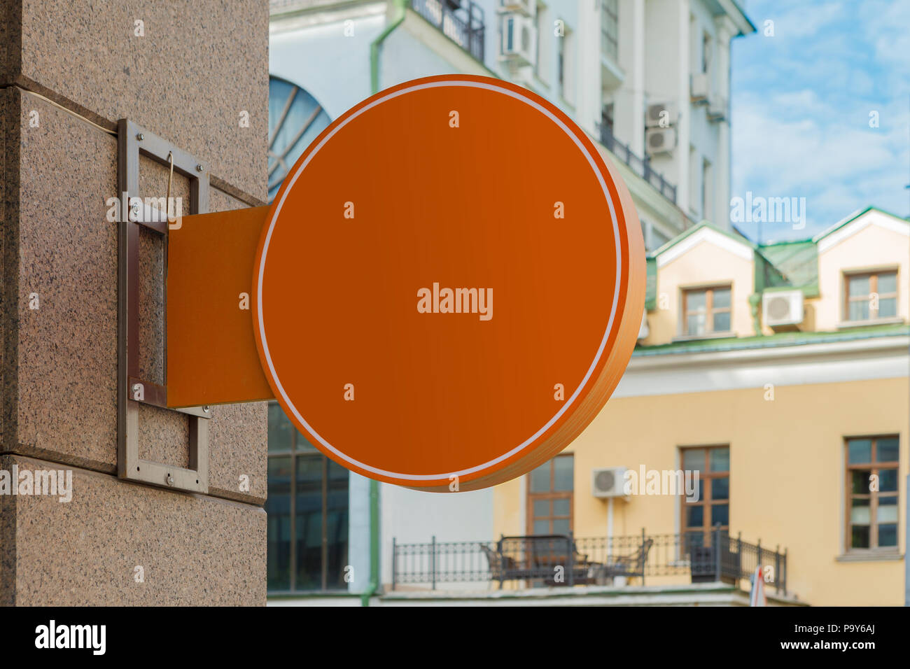 Blank orange round signboard on the granite wall Stock Photo - Alamy