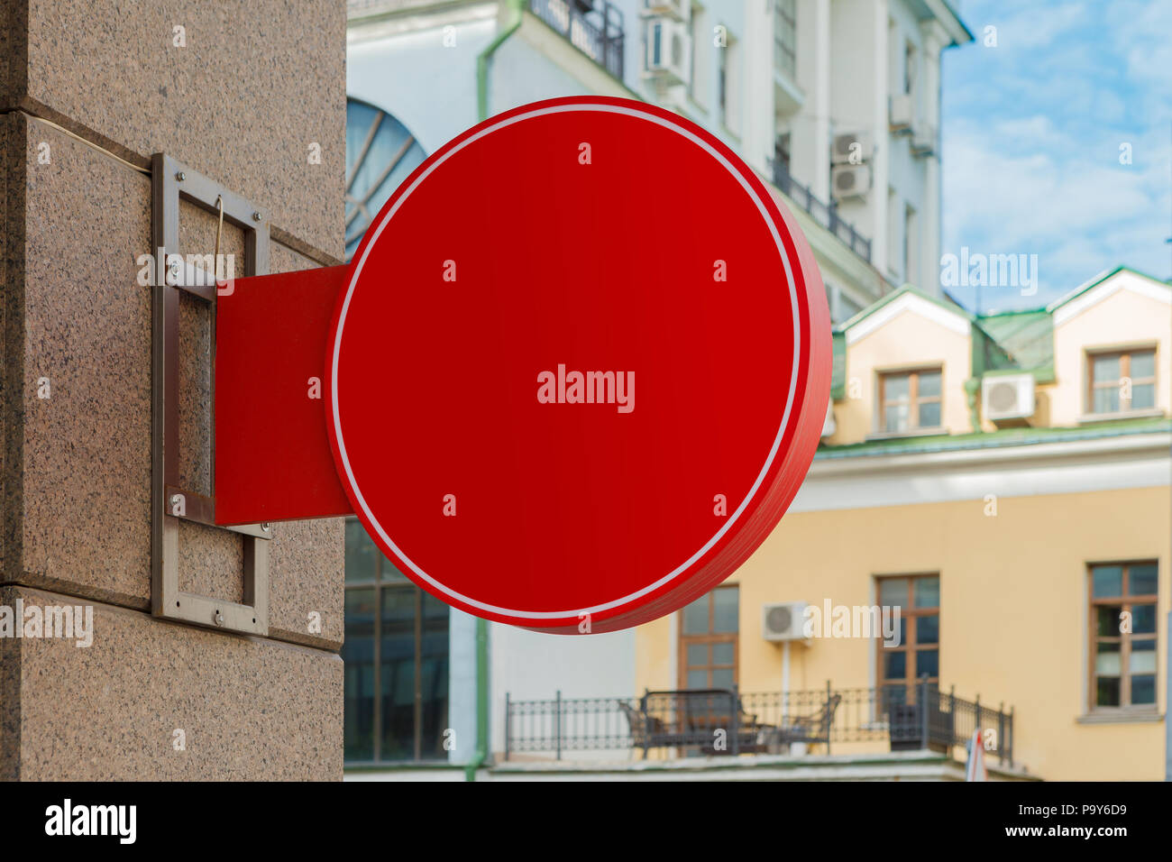 Blank red round signboard on the granite wall Stock Photo - Alamy