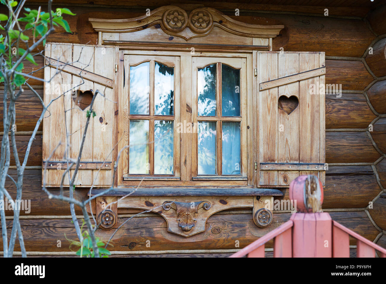 Wooden window with shutters in a wooden farmhouse. Open the shutters ...