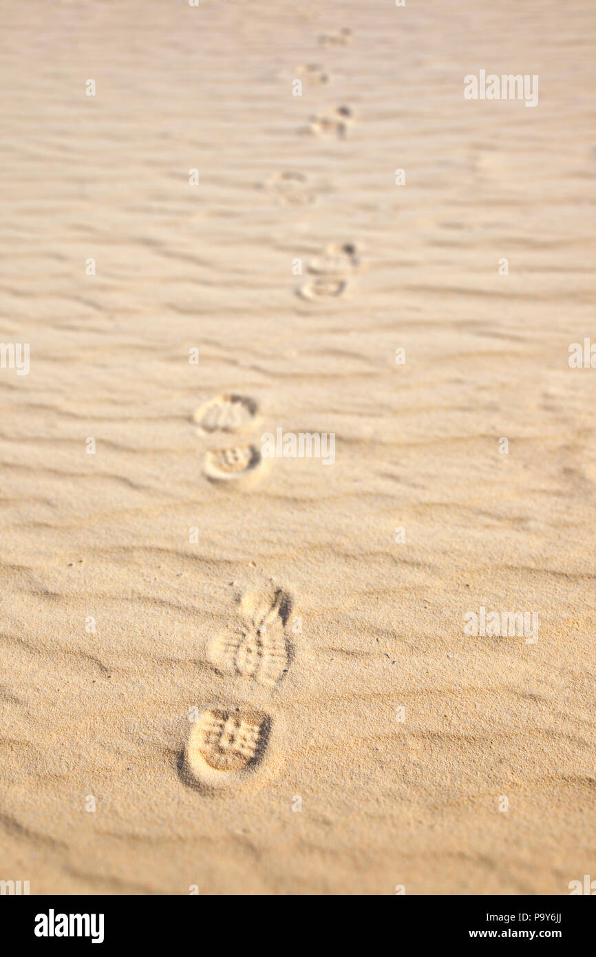 A photography of some footsteps in the sand Stock Photo - Alamy
