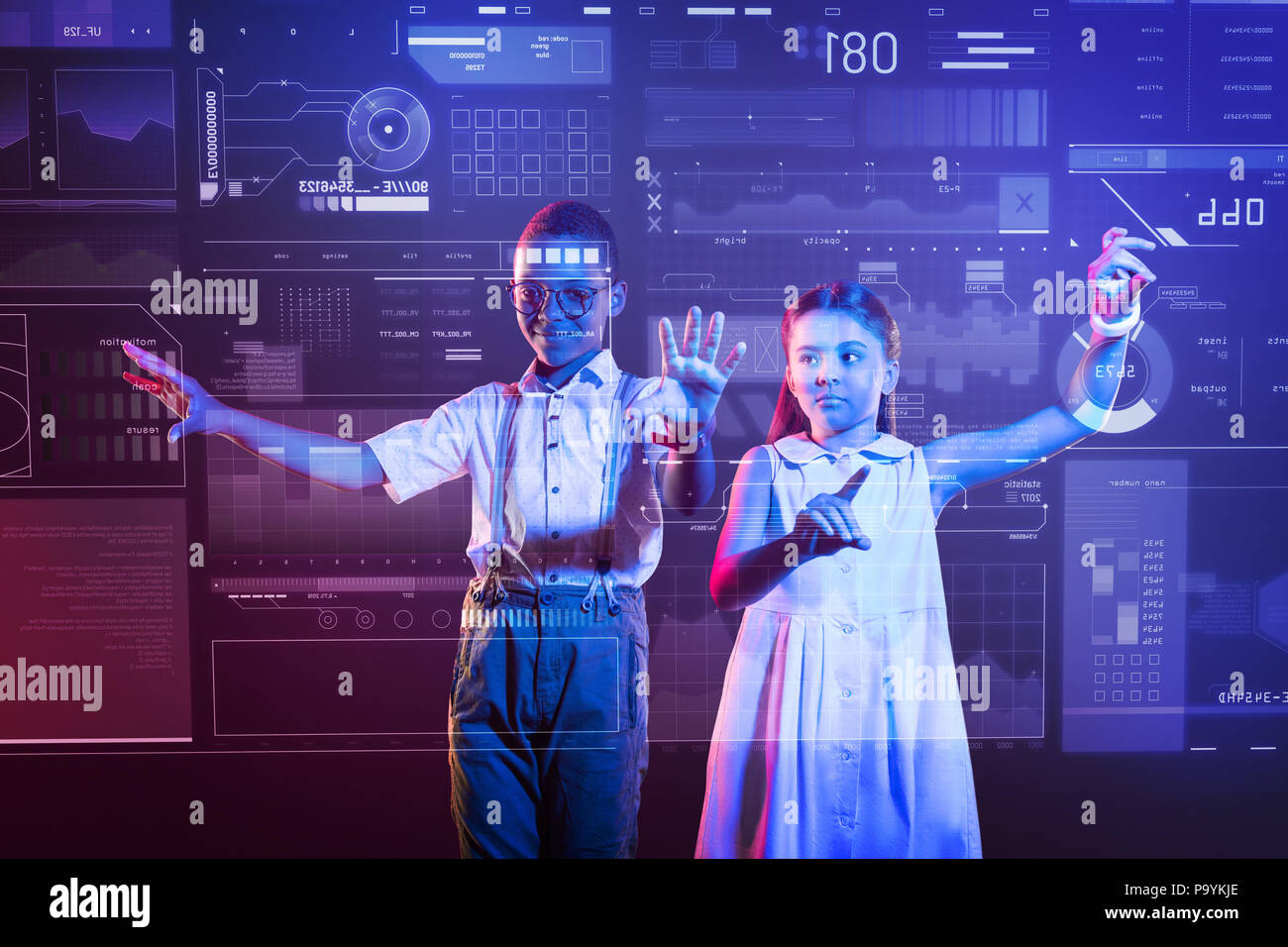 Clever children standing together and using modern technologies Stock ...