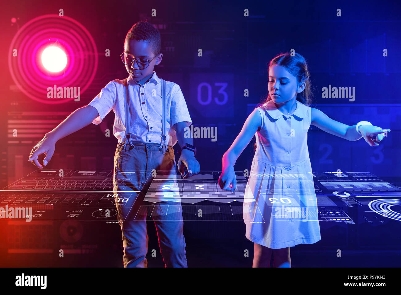 Calm kids looking busy while touching the icons on the screen Stock ...