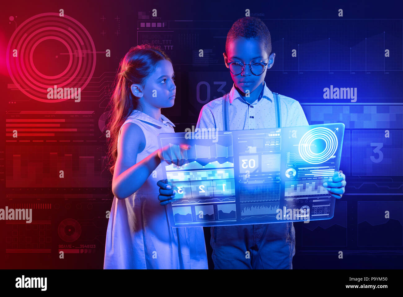 Careful boy holding a soft transparent device and his friend pointing ...