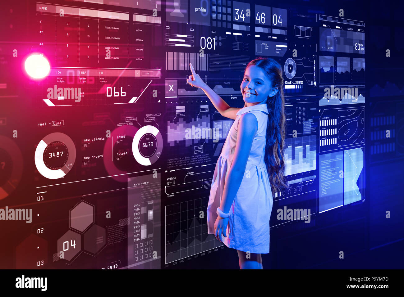 Pretty girl smiling and showing her new futuristic computer Stock Photo ...