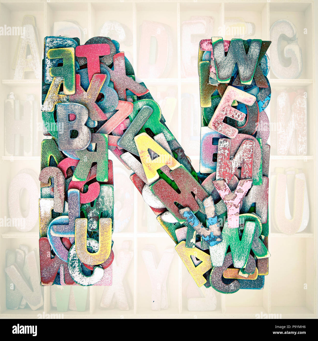 lots of small wooden letters to make up the letter N Stock Photo - Alamy