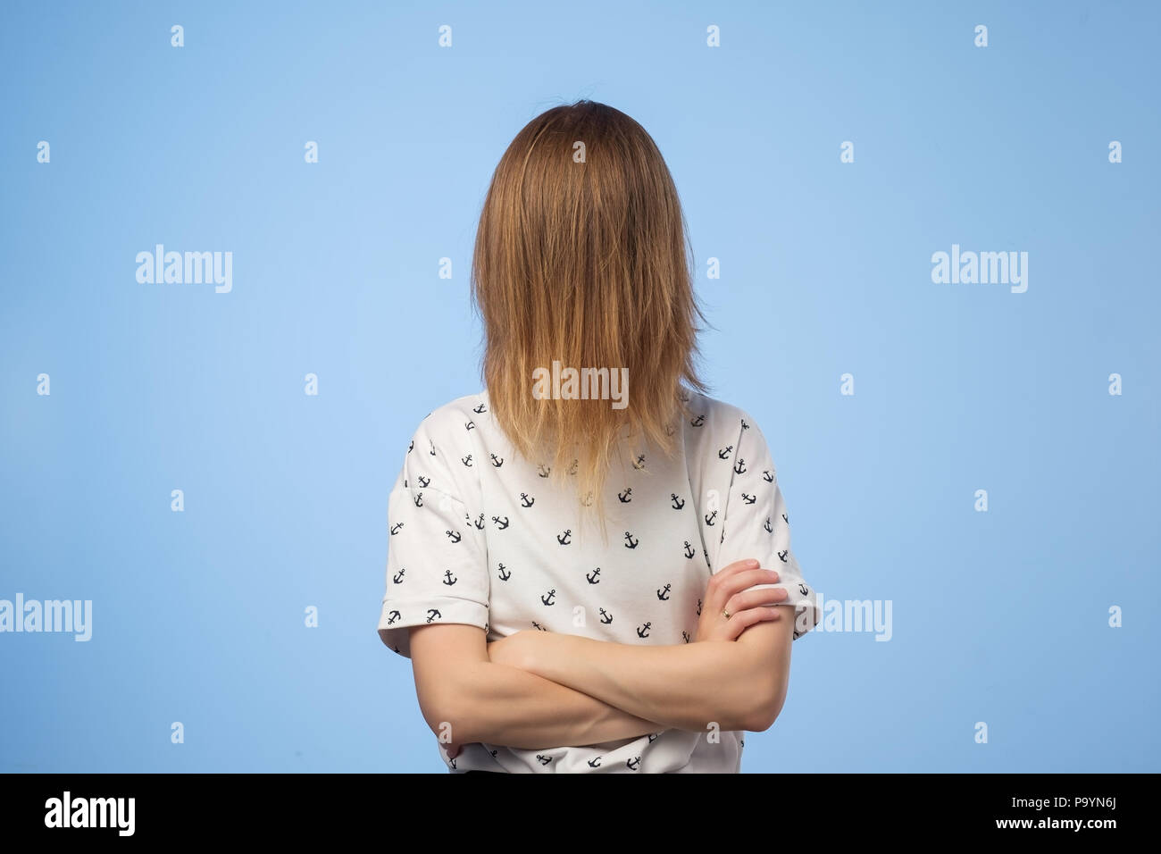 An european woman covered her face with her hair, trying to hide ...