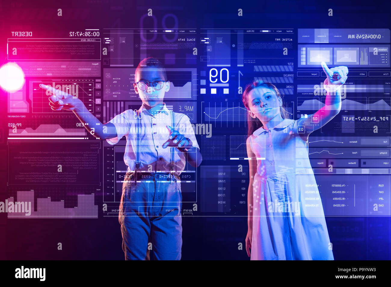 Serious children touching a transparent screen and looking calm Stock ...