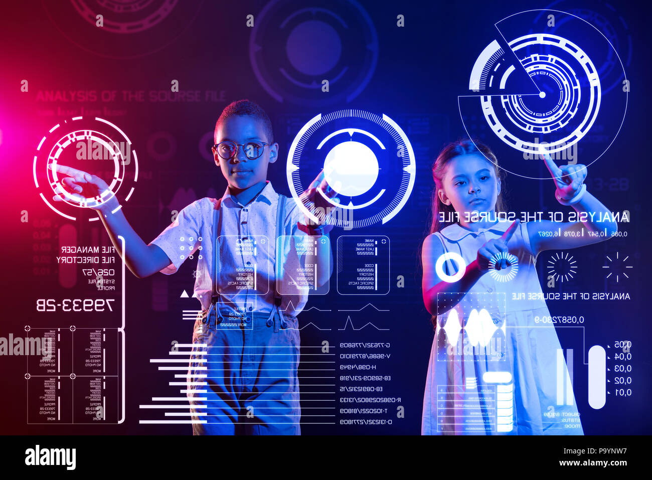 Progressive children looking calm while touching the screen Stock Photo ...