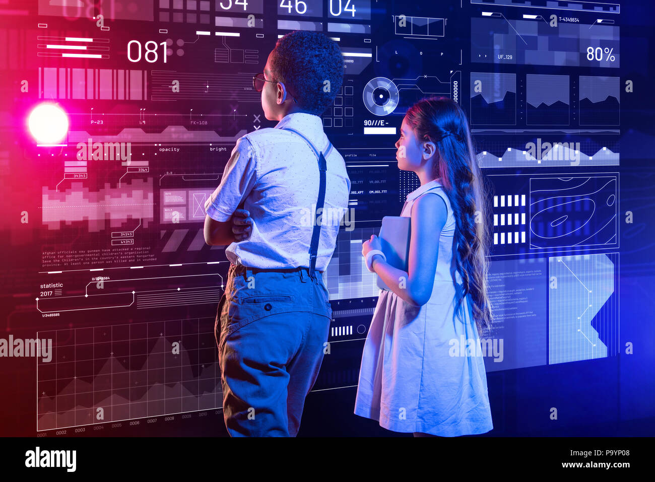 Boy and girl looking at the screen and thinking Stock Photo - Alamy