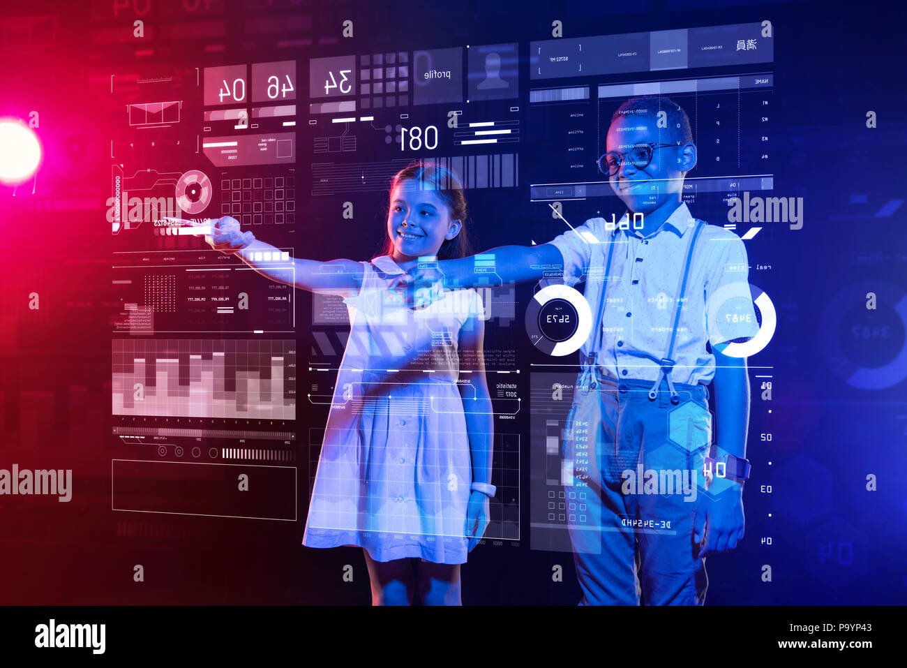 Friendly kids putting their remote controls up and smiling Stock Photo ...