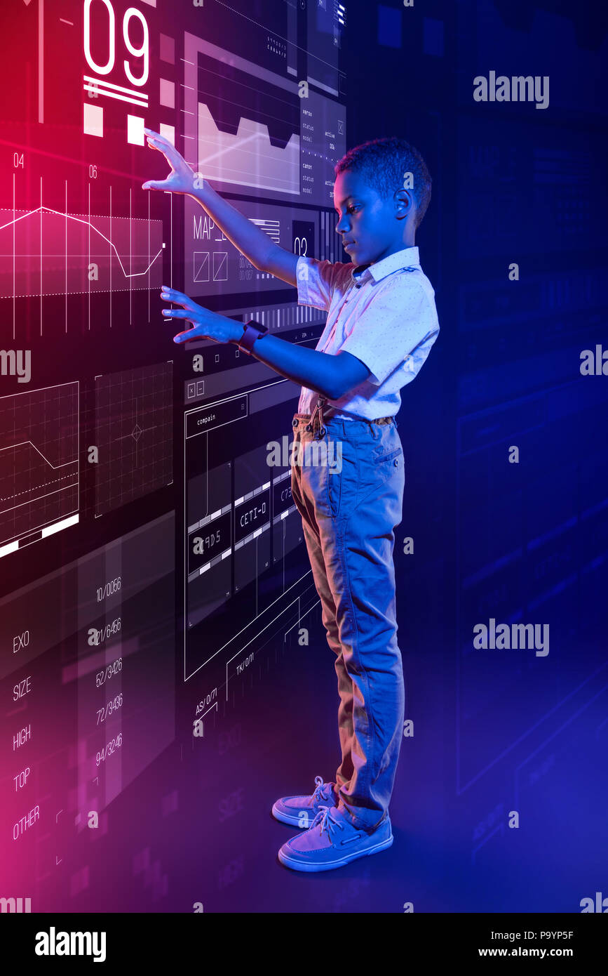 Future programmer controlling the computer system and looking serious ...