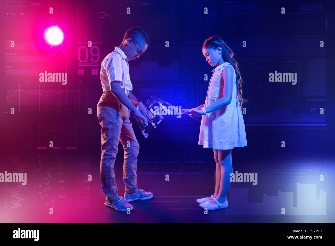 Calm kids standing opposite each other and touching the holographic ...